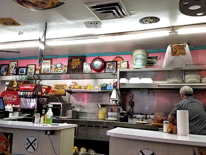 Where the magic happens &ndash; vintage signs watch over the grill as breakfast classics come to life. The kitchen's heartbeat is almost audible.