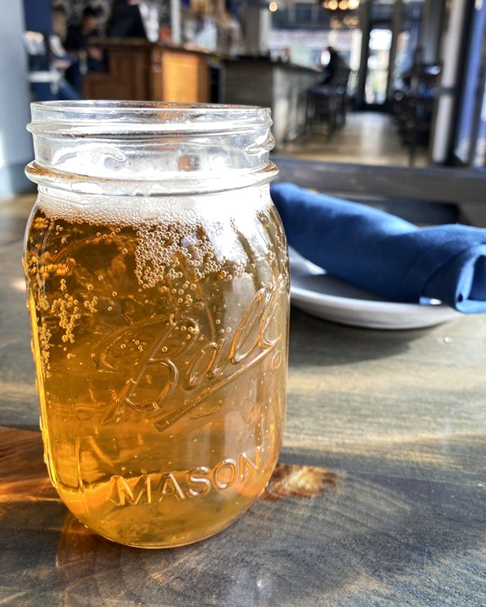 Beer served in a mason jar&mdash;because Southern hospitality demands proper glassware be optional. Cold, amber, and ready for sipping between bites.