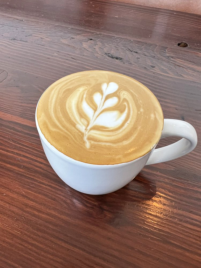 Latte art so pretty you almost don't want to drink it. Almost. That leaf design is practically begging for its Instagram moment. 