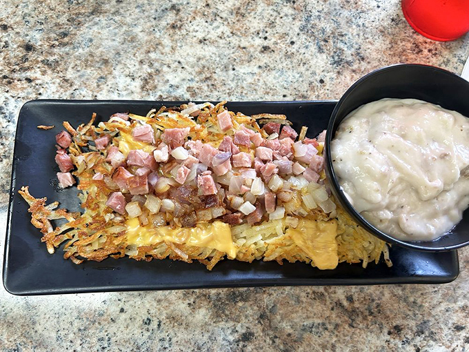 Loaded hash browns that don't know the meaning of restraint – crispy potatoes topped with ham and cheese, with gravy standing by for extra indulgence.