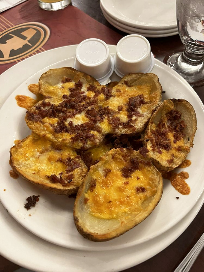 Loaded potato skins that remember what bar food was before kale tried to crash the party. Simple, satisfying, and unapologetically cheesy.