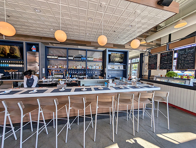 Bar seating that encourages conversation. The long counter with its blue accents and globe lighting creates the perfect perch for solo diners or social butterflies.