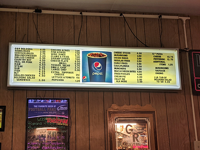 The illuminated menu board glows like a beacon of hope for the hungry, with prices that'll make city folks do a double-take. 
