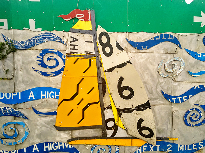 Sailing the high seas of creativity, this little vessel navigates waves made from "Adopt A Highway" signs, proving even the most utilitarian objects can find poetic purpose.