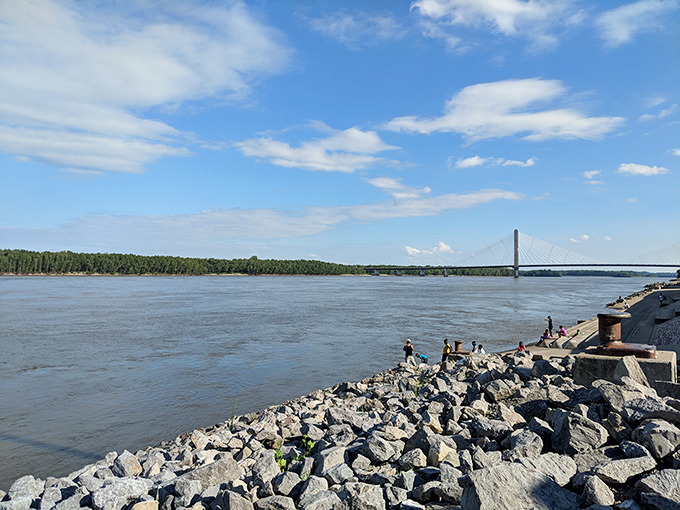 The mighty Mississippi flows past Cape's rocky shoreline, carrying barges, stories, and the very soil that built this riverside community.