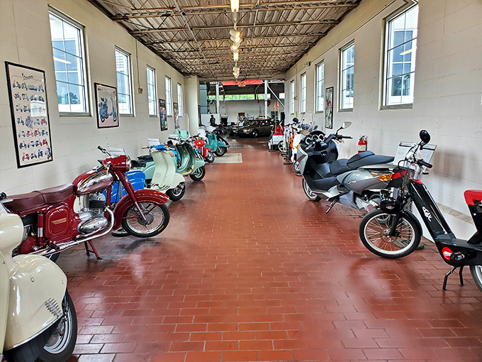 A corridor of two-wheeled history where vintage motorcycles and scooters stand at attention, each with its own story of wind-in-your-hair freedom.