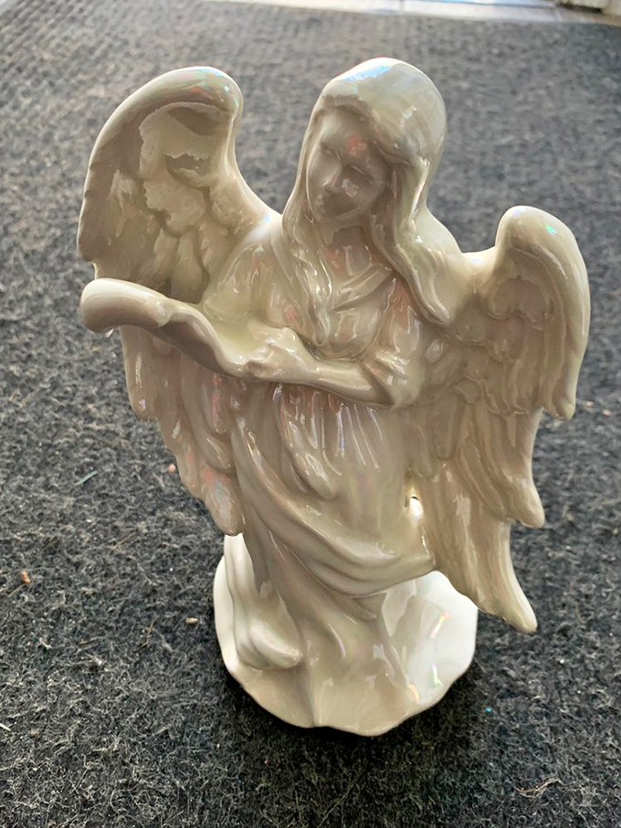 This pearlescent angel figurine isn't just decor&mdash;it's someone's former guardian of the mantelpiece, ready to watch over a new home.