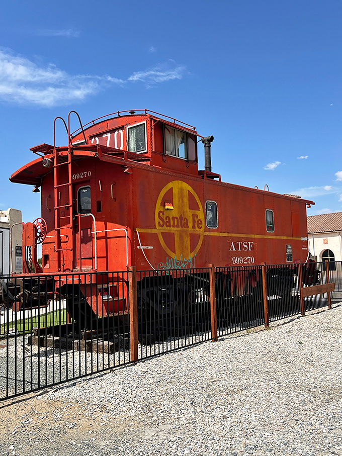 The mighty Santa Fe caboose stands guard outside, a crimson reminder of when railways and highways competed for America's heart.