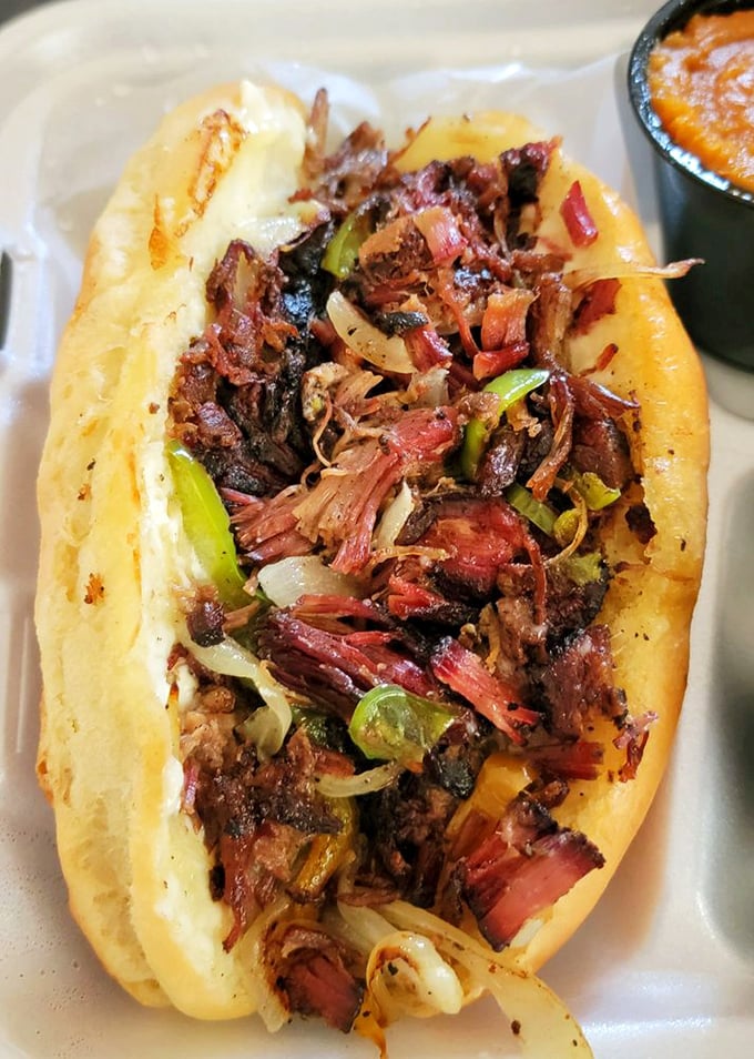 A sandwich so packed with smoky meat and peppers that it requires both hands and possibly a signed liability waiver.