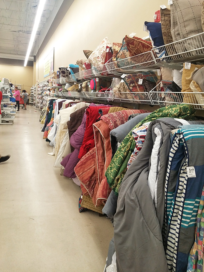 Textile treasures stacked high&mdash;from Southwest-patterned throws to practical comforters, each with previous lives and new possibilities.