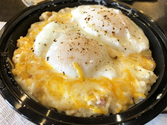 Cheesy grits crowned with perfectly poached eggs – Southern comfort in a bowl that would make any grandmother nod in approval.