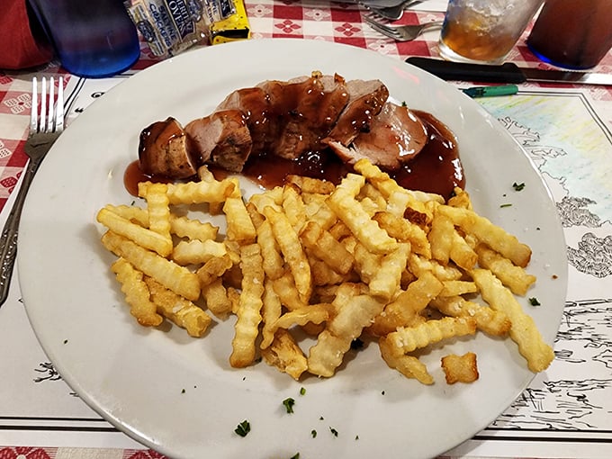 Sliced pork tenderloin with gravy and fries&mdash;the kind of plate that makes you want to befriend farmers just to ensure the supply chain stays intact.