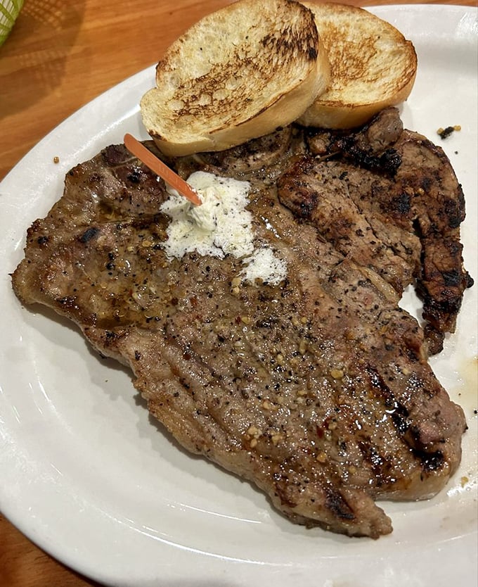 A steak so substantial it has its own gravitational pull. The perfectly caramelized exterior is a masterclass in proper grilling technique.