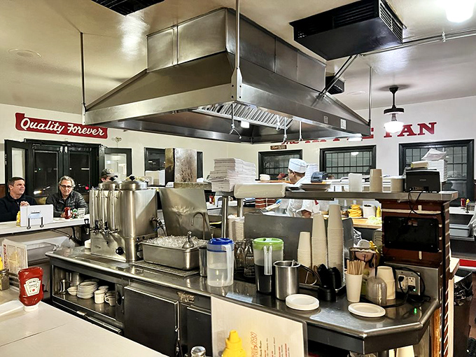 The open kitchen layout isn't a modern design choice &ndash; it's how they've always done it, letting you watch your burger's journey from patty to perfection with nothing to hide.