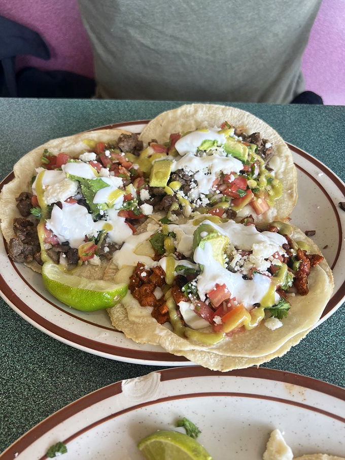 These tacos arrive dressed for success with a confetti of fresh toppings and a squeeze of lime that brightens everything like good news on a Monday.