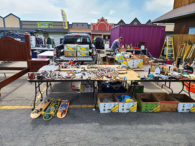 A handyman's dream buffet. From skateboards to screwdrivers, this vendor's eclectic spread proves that organization is merely a suggestion, not a requirement.