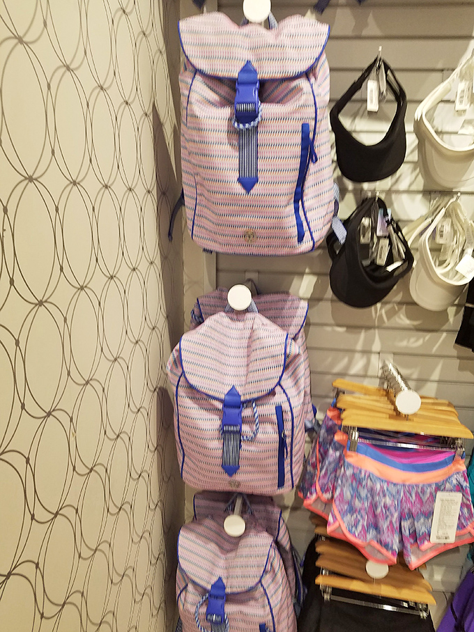 Stylish backpacks with blue accents hang in perfect formation &ndash; back-to-school shopping without the back-to-school prices.