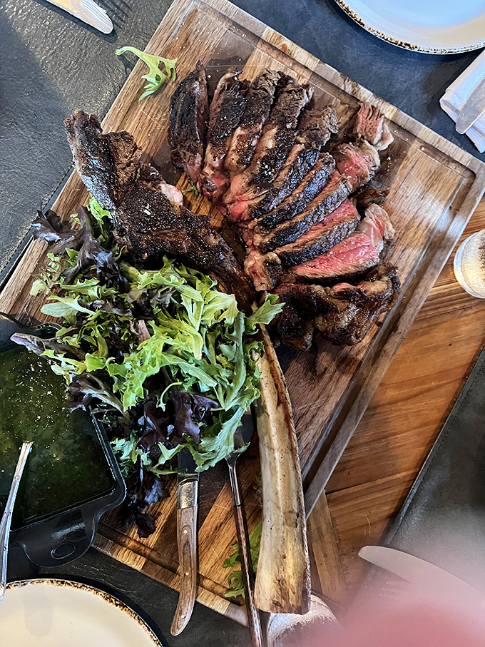A ribeye so perfectly sliced it could teach geometry classes, with a side of greens to pretend you're eating healthy.