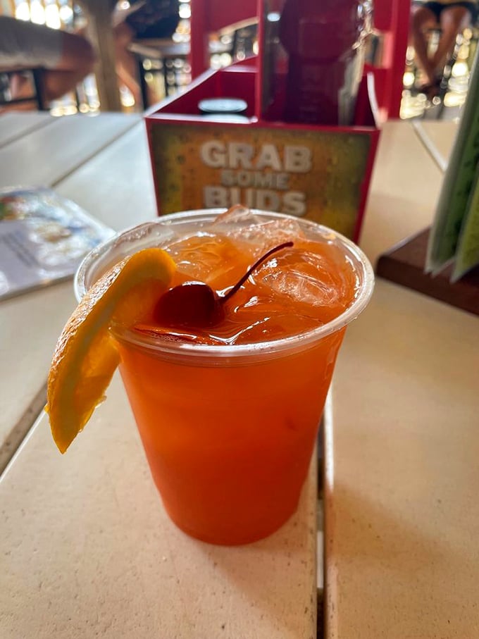 This rum punch, with its sunset hues and cherry garnish, isn't just a drink &ndash; it's liquid Florida sunshine in a plastic cup.