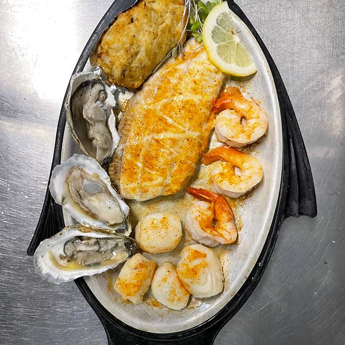The seafood sampler that answers all of life's important questions. Oysters, scallops, shrimp, and fish create an oceanic symphony on a boat-shaped plate.
