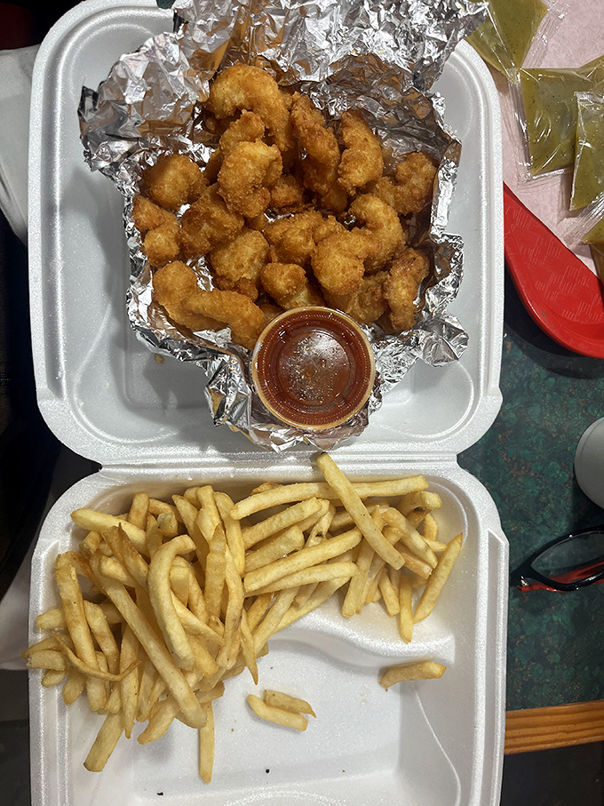 Golden-fried treasures from the sea nestled beside perfectly cooked fries&mdash;proof that this kitchen knows its way around more than just beef.