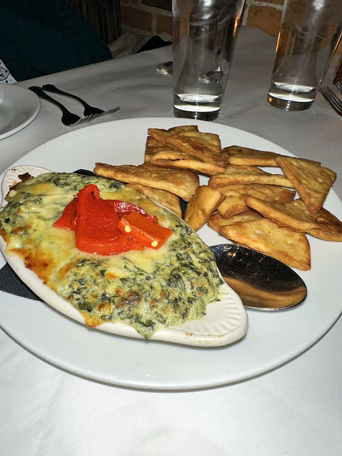 This spinach artichoke dip, bubbling with cheese and served with house-made pita chips, is what appetizer dreams are made of.