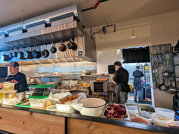 Kitchen staff working their magic in full view, proving transparency makes everything taste even better somehow.