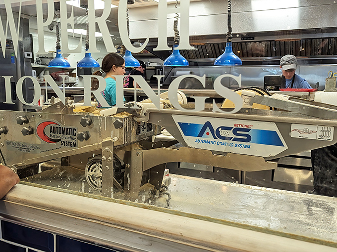 Behind this glass lies the magic&mdash;where Lake Erie's bounty meets breading perfection. The blue lights add a touch of underwater theater to the process.