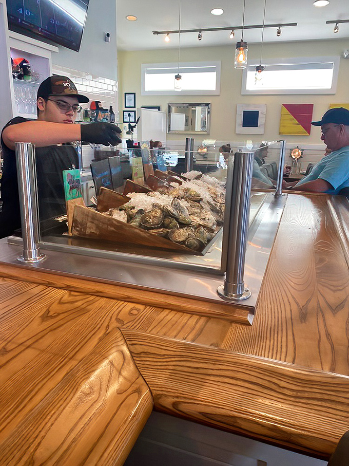 Fresh oysters being prepared with care&mdash;a front-row seat to seafood theater where the ocean's treasures take center stage.