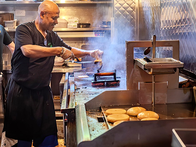 Behind every great burger is a grill master with the focus of a surgeon. The sizzle and smoke create a primal symphony that makes waiting almost bearable.