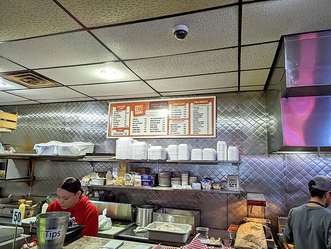 Behind every great burger is a dedicated kitchen team. The open layout lets you witness the choreography of comfort food creation.