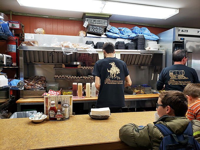 Kitchen choreography at its finest. The staff works with practiced precision in a space where every inch matters.