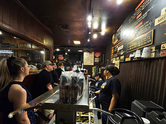 The line moves with practiced efficiency&mdash;a barbecue ballet where patience is rewarded with meat that makes waiting feel like the smartest decision you've made all week.