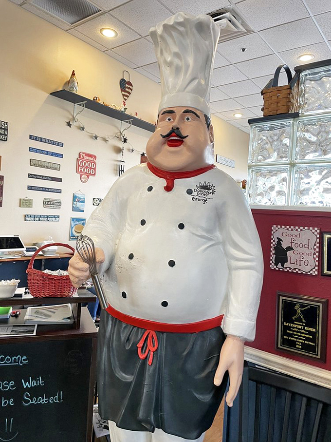 Every great diner needs a mascot, and this chef statue stands guard, silently judging those who order their eggs well-done.
