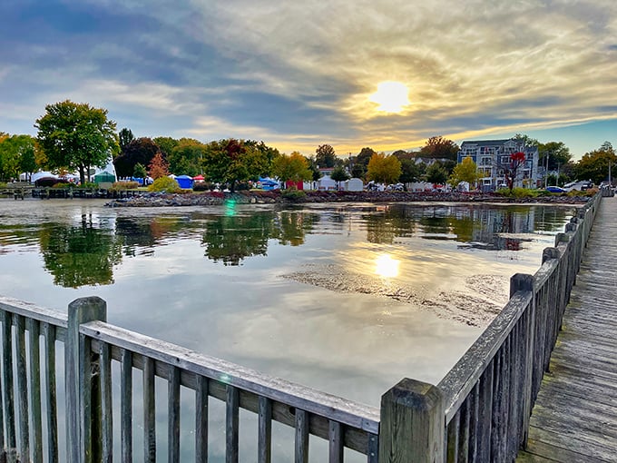 Sunset reflections double the beauty at the waterfront, where even the most dedicated phone-checkers pause to appreciate nature's evening show.
