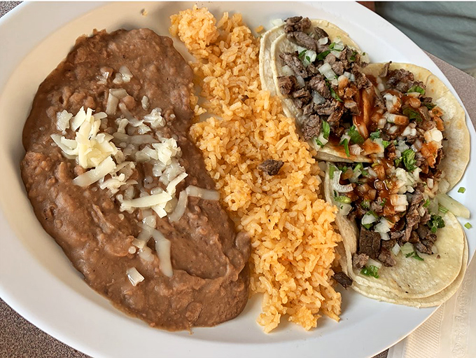 The taco plate that makes you question why you ever ate anywhere else. Rice, beans, and tacos in perfect harmony.