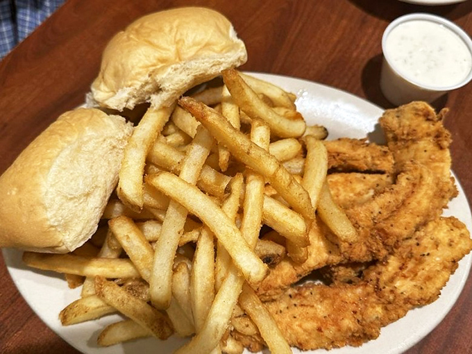 Chicken tenders that make you realize why the phrase "comfort food" was invented, paired with fries that achieve the perfect crisp-to-fluffy ratio.