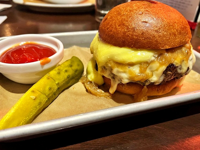 Cheese cascading down a perfectly cooked patty like a delicious waterfall. That pickle stands guard, ensuring maximum flavor balance.