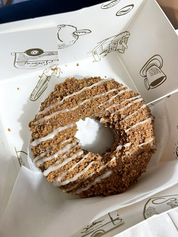 This coffee cake donut with its perfect glaze drizzle proves that sometimes the classics deserve their legendary status for good reason.