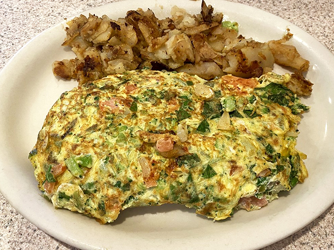 An omelet that's not afraid to show its personality. Packed with veggies and paired with those perfectly crisped potatoes&mdash;breakfast doesn't get more honest than this.