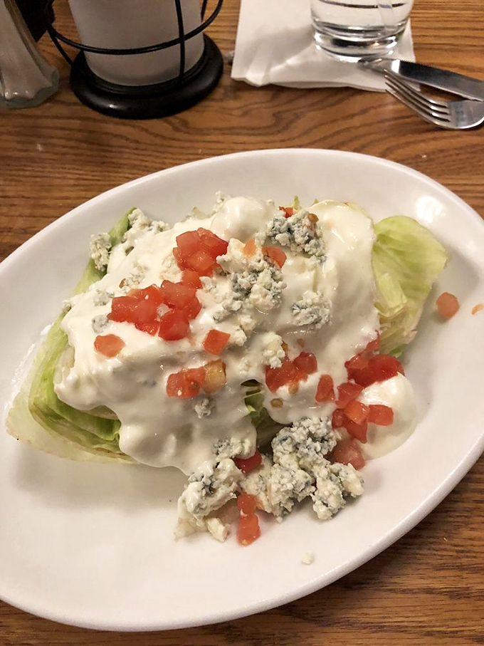 The wedge salad: that rare moment when iceberg lettuce gets to be the star, dressed in blue cheese and diced tomatoes like it's heading to the Oscars.