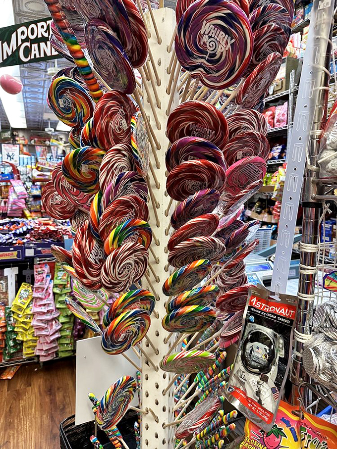 The lollipop forest grows tall with swirled sugar discs, a psychedelic garden of sweetness that would make Willy Wonka himself stop and stare.