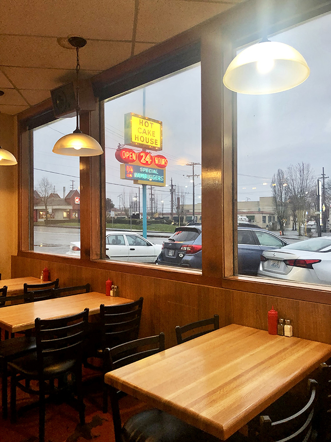 Through these windows, you can watch the world go by while staying firmly planted in breakfast paradise. The neon sign promises 24-hour salvation