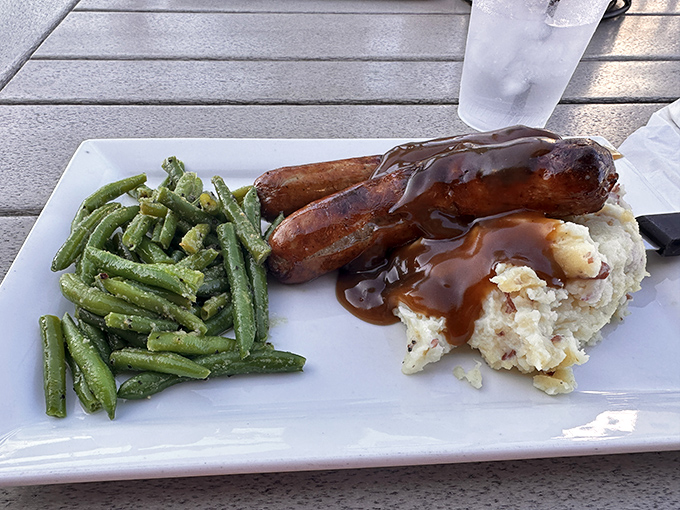Traditional bangers and mash with rich gravy delivers exactly what your comfort food cravings demand.