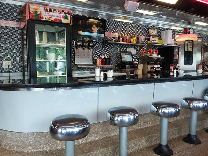 The counter seating offers front-row tickets to the short-order cooking show, where coffee cups are never empty and conversation flows freely.