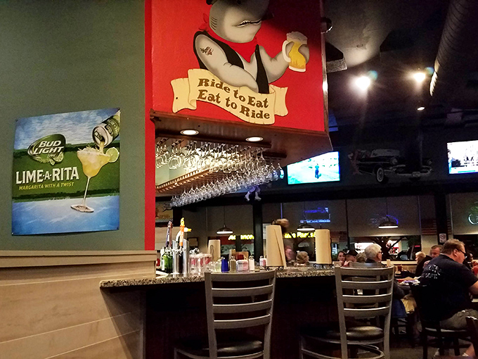 The bar area where cold beverages meet warm hospitality and every seat offers front-row food theater.