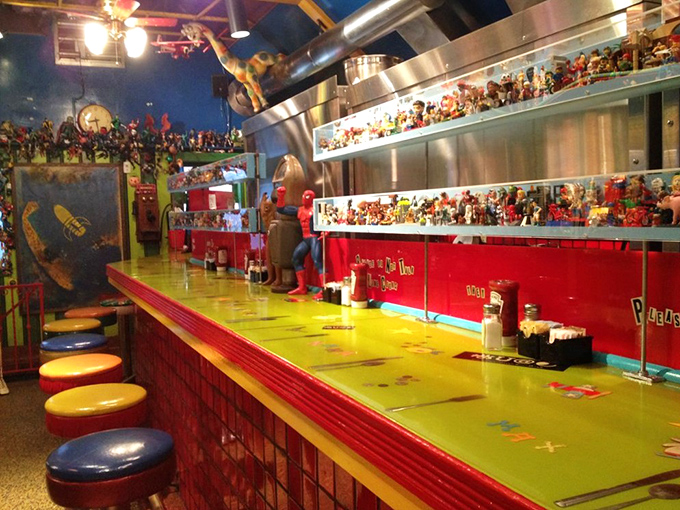 The counter seating offers front-row tickets to the culinary show, with action figures standing guard over your dining experience.