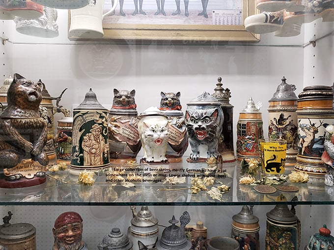 This collection of ornate cat-themed beer steins proves that even German drinking traditions couldn't escape the charm of our feline friends.