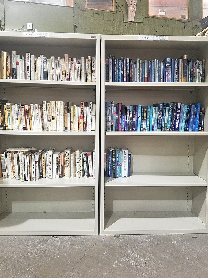 Books organized with just enough method to make the madness enjoyable. Fiction and non-fiction neighbors create unexpected literary conversations across these white shelves. 