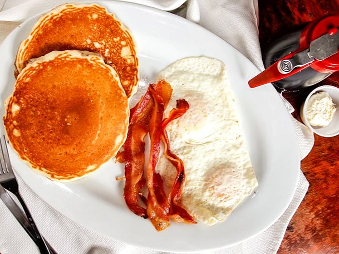Pancakes so perfectly golden they make the sunrise jealous, with bacon standing by like a faithful sidekick.